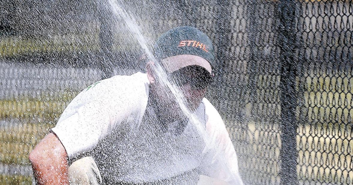 Technician checks sprinklers at Yost baseball field | | winchesterstar.com