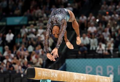 Simone Biles fights through calf injury to produce impressive ...