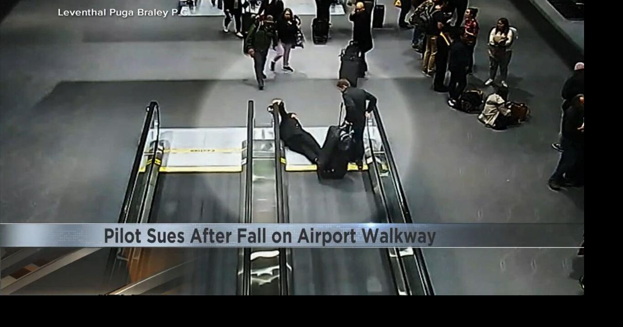 Pilot falls on moving walkway at Denver International Airport | Video ...