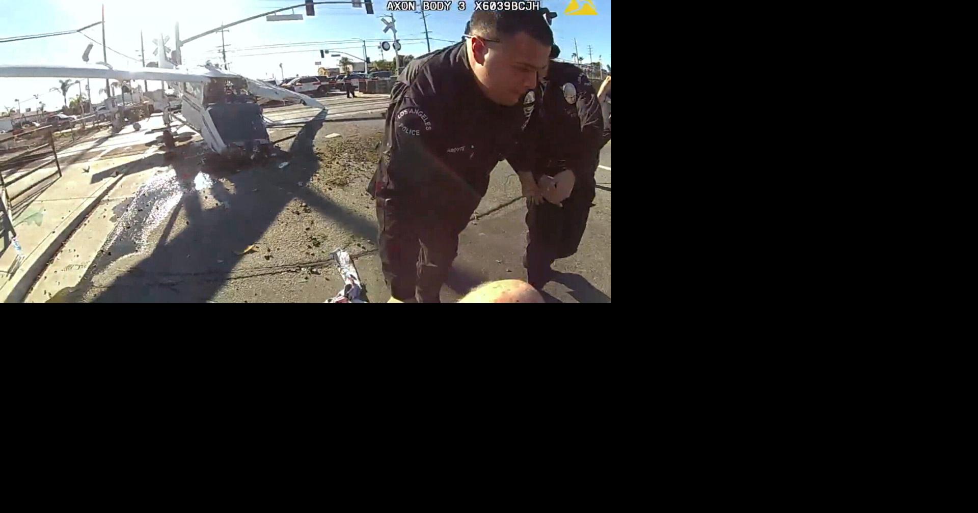 Officers pulled an injured pilot from a crashed plane moments before a ...