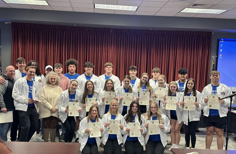 Local leaders honor cheer squad and late artist during monthly meeting ...