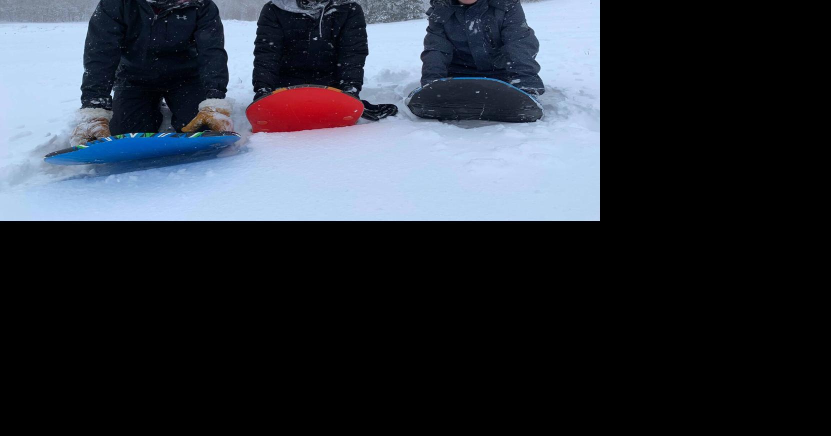 Fresh snow falls as friends and families go sledding at Pinehurst Park ...