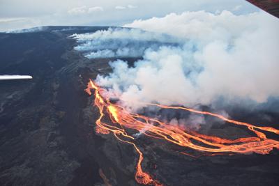Drivers are warned of lava inching toward a key highway as 2 volcanoes ...