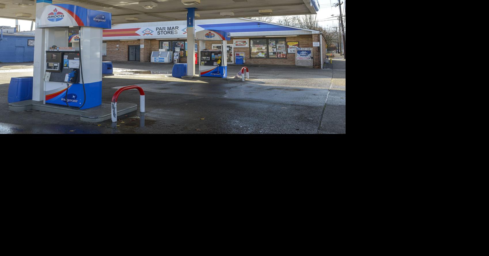 Employees working near temporarily shuttered convenience store express ...