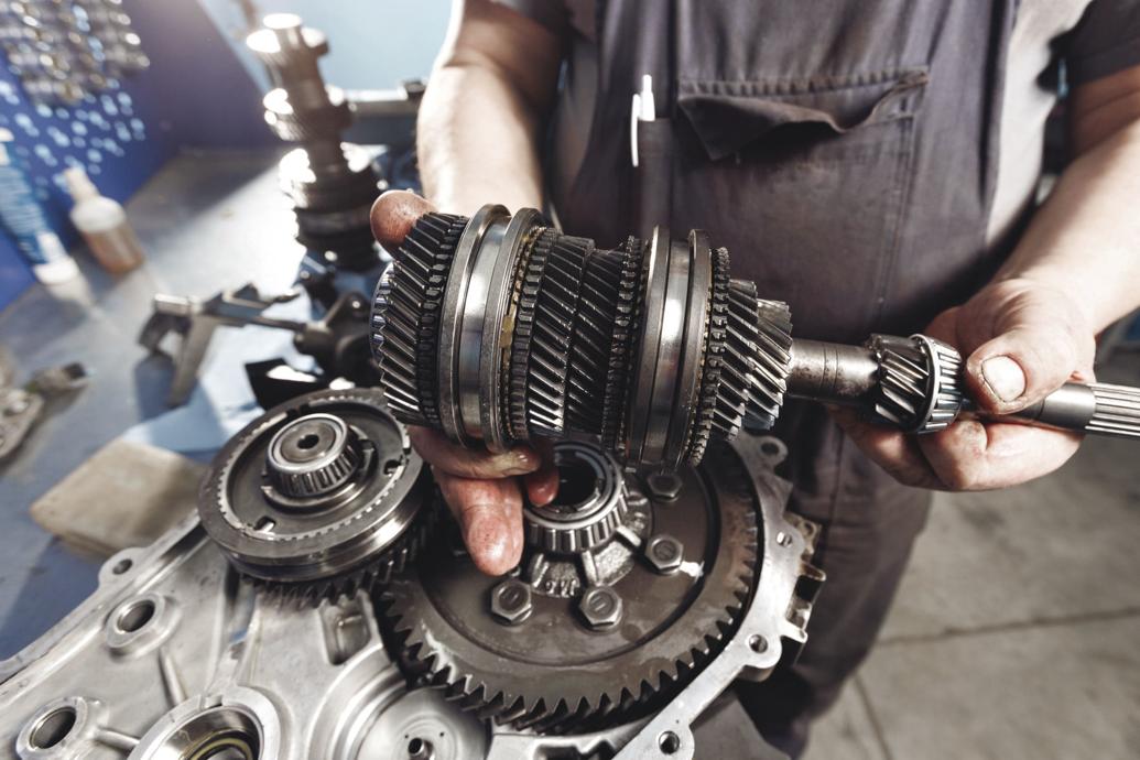 Cross-section of a car gearbox. mechanics work in the garage. hand ...