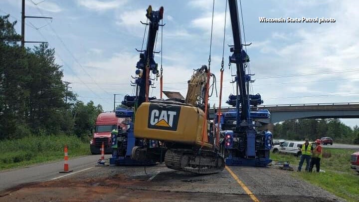Backhoe strikes overpass, falls off trailer near Black River Falls ...