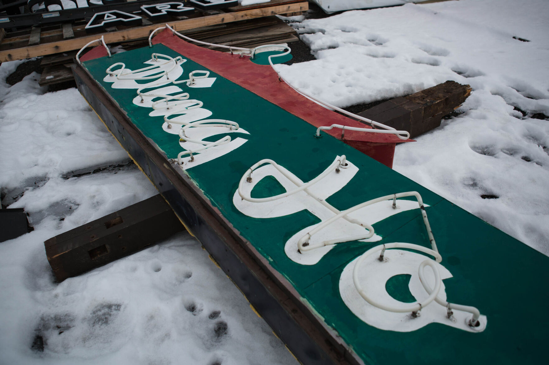 Two historic neon signs are being restored, with a plan to display them ...