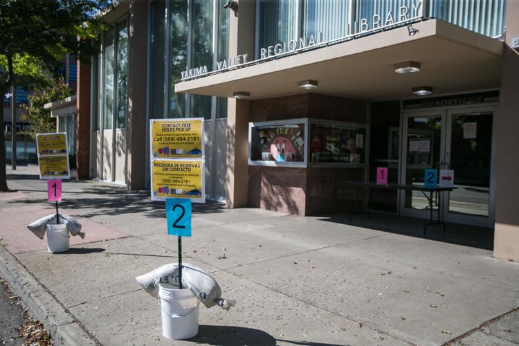 Library patrons welcome chance to check out books again with curbside ...