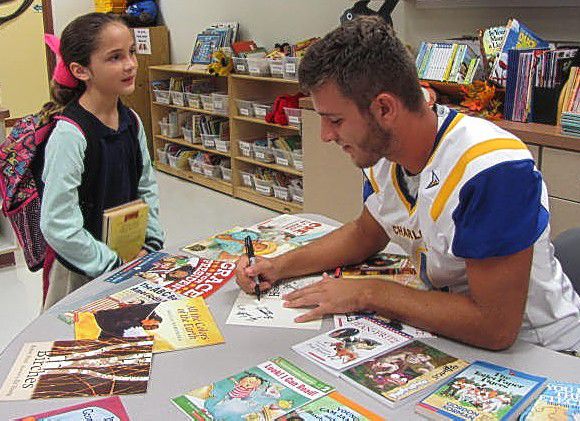 Football players promote reading at Peace River | News Archives ...