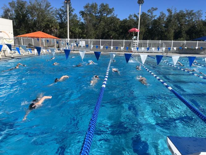 College swimmers from around nation train locally, benefit economy ...
