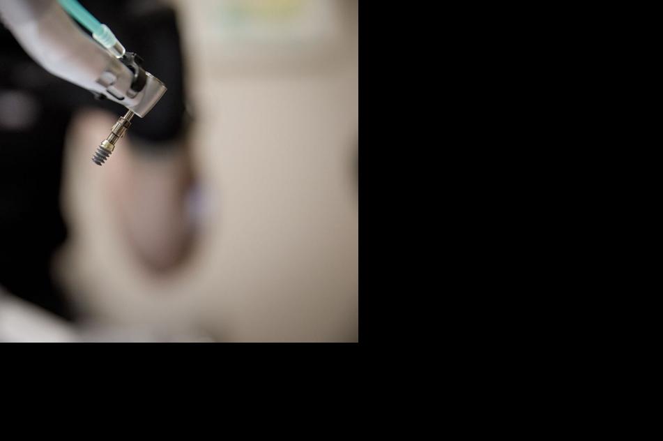 Oral surgeon has help when drilling implants. Meet his robotic ...